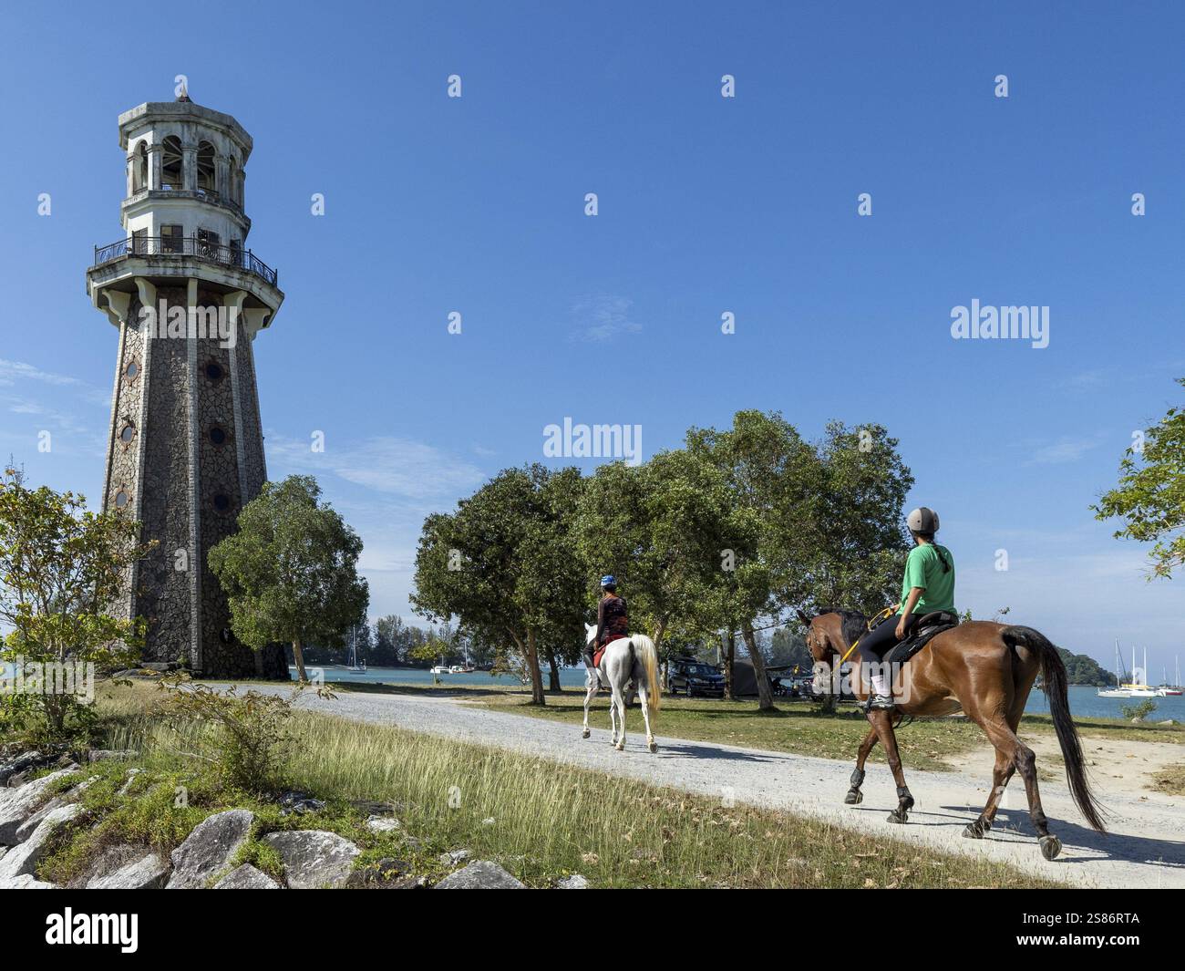 Rider at Perdana Quay lighthouse, Telaga, Langkawi, Kedah state ...