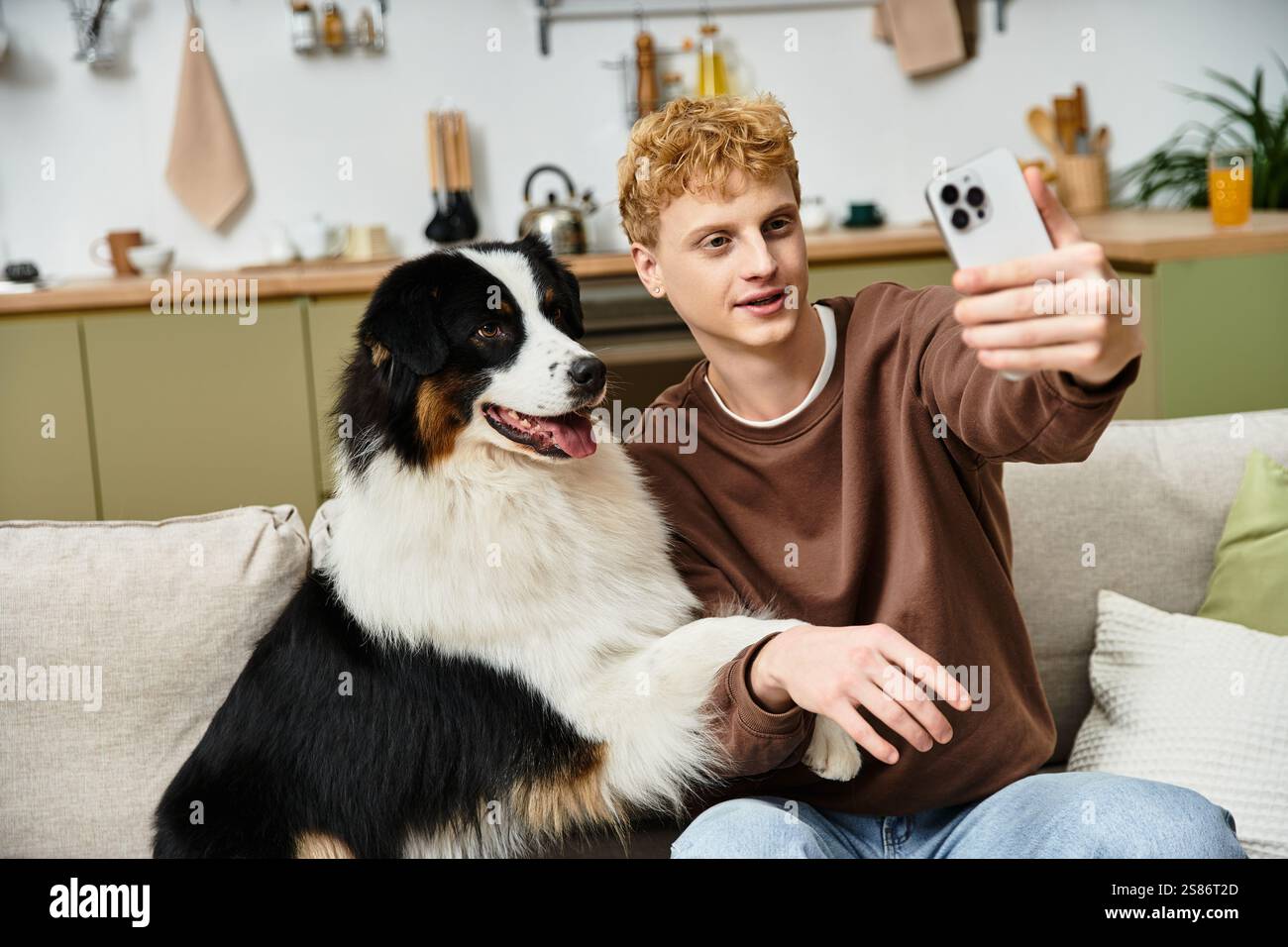 A red-haired young man shares a sweet moment with his Australian ...
