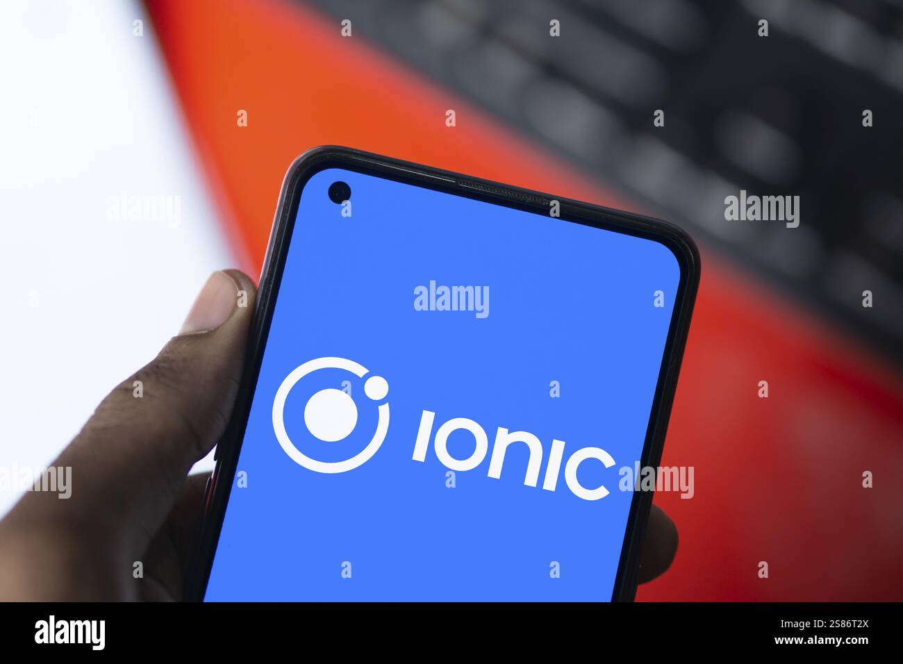Ionic logo is displayed on smartphone. Ionic is an open-source UI toolkit for building cross ...