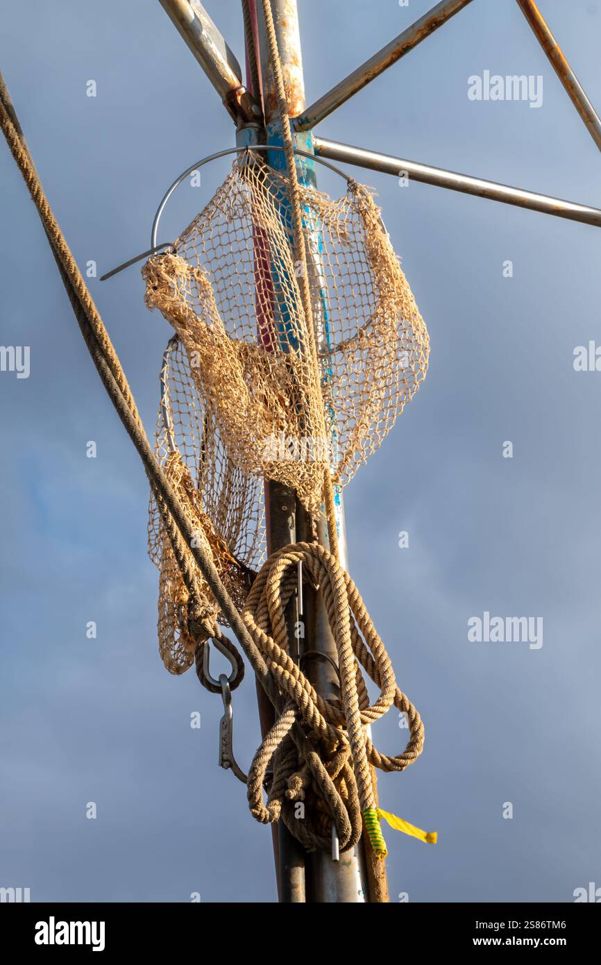 Two fishing nets getting dry on a mast. Rainy cloudy sky in the ...