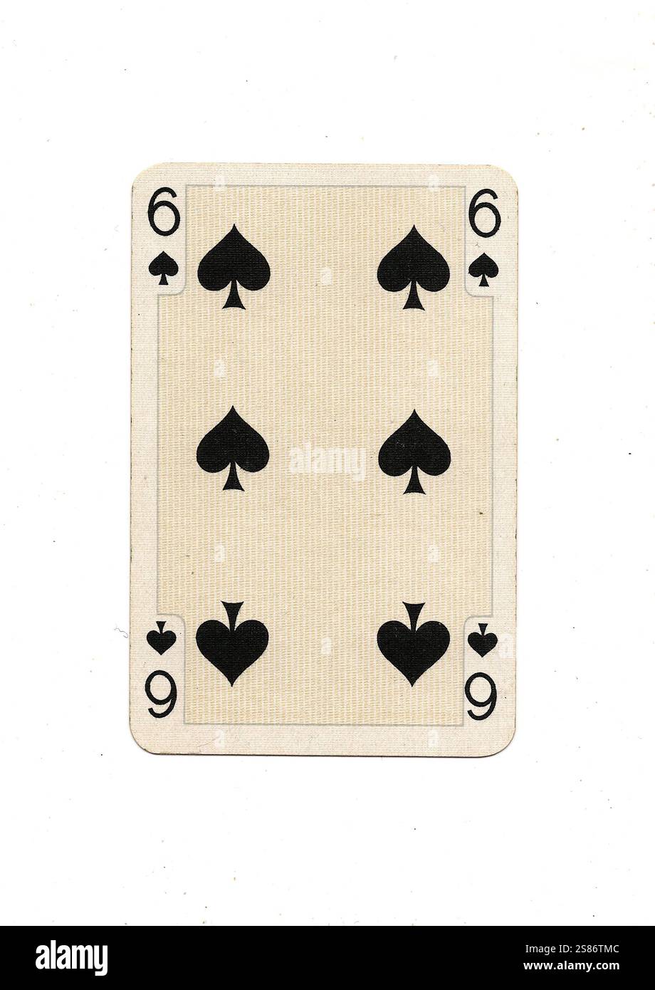 An antique six of spades playing card isolated on a white background ...