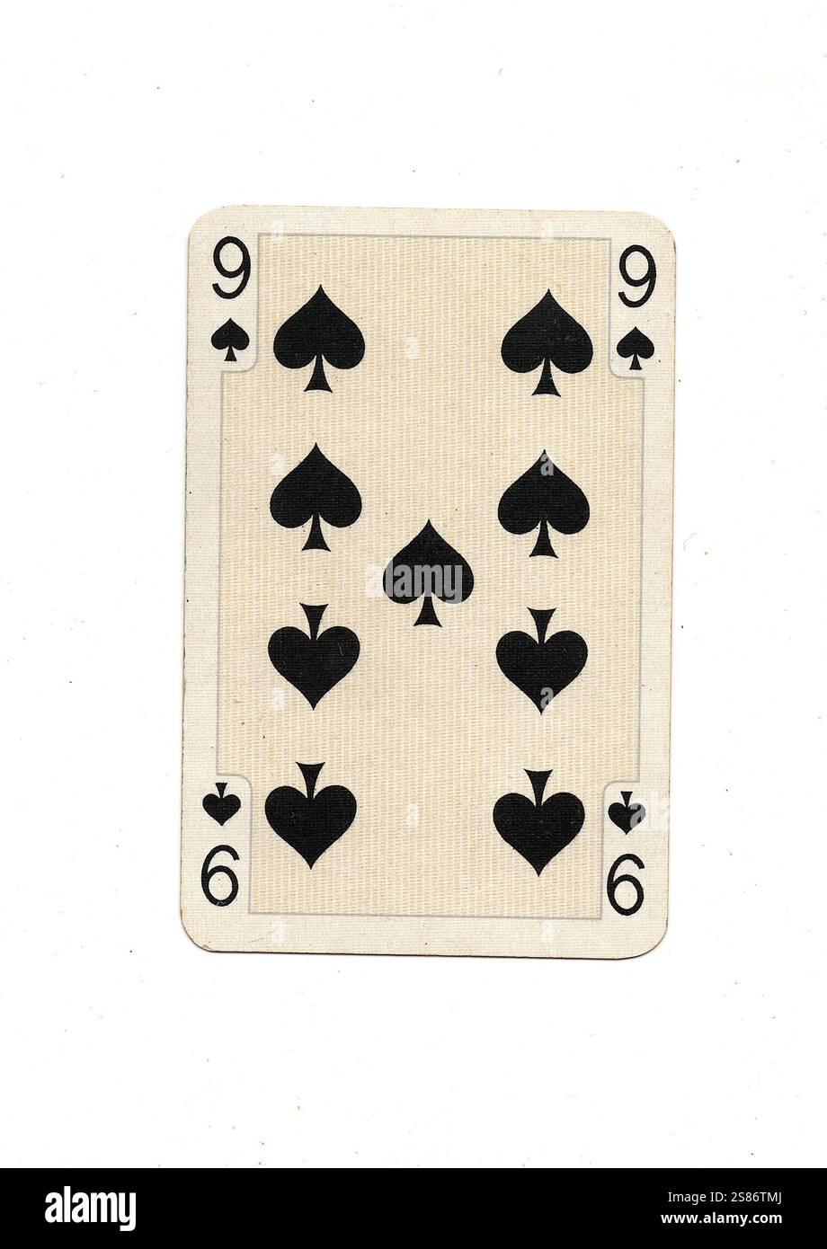 An antique nine of spades playing card isolated on a white background ...