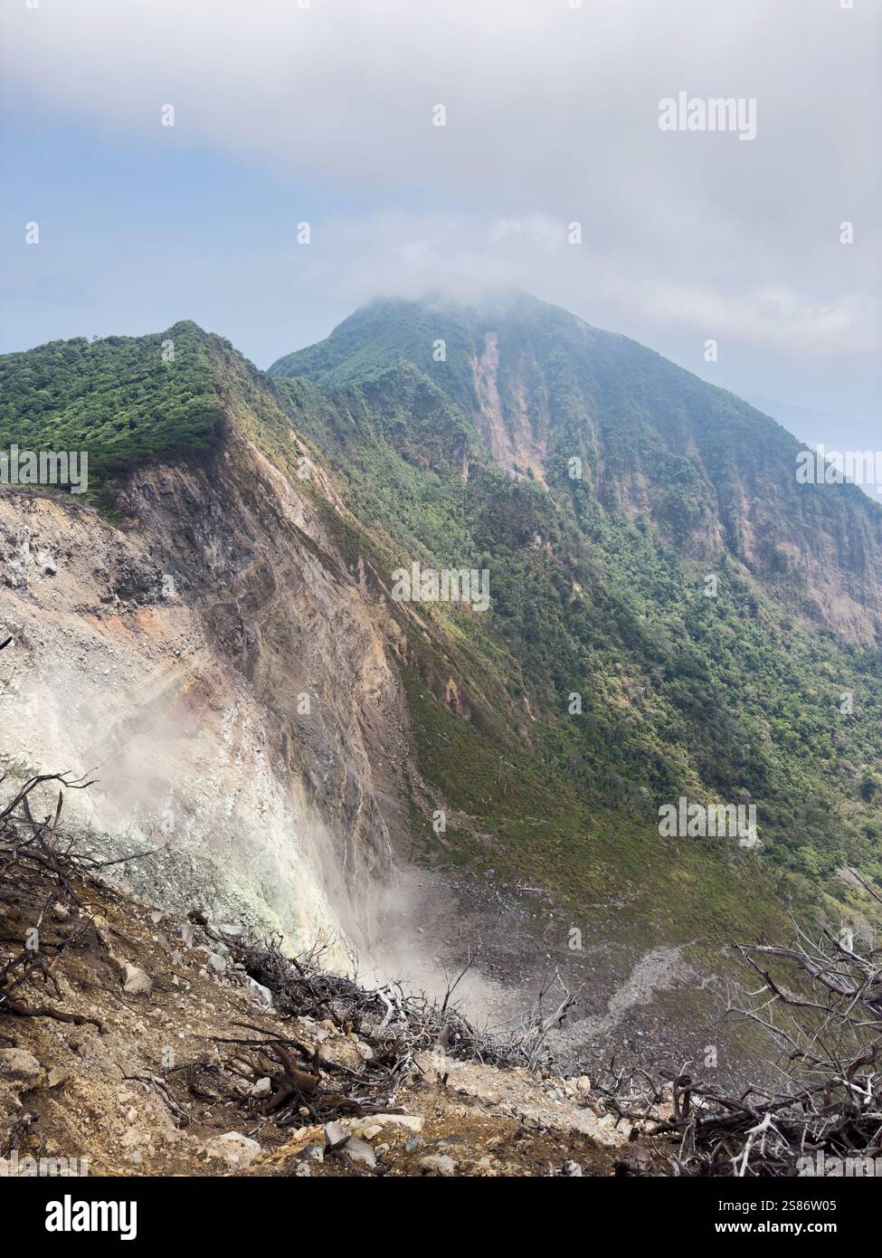 Volcano mountain cliff landscape with green forest for hike Stock Photo ...