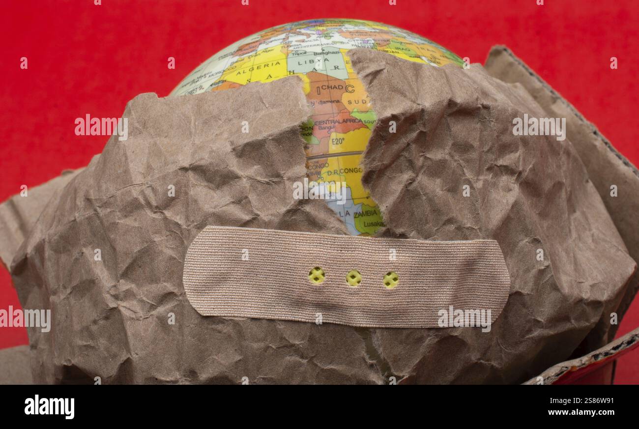 Earth with bandaided paper Solidarity and aid to countries in need ...