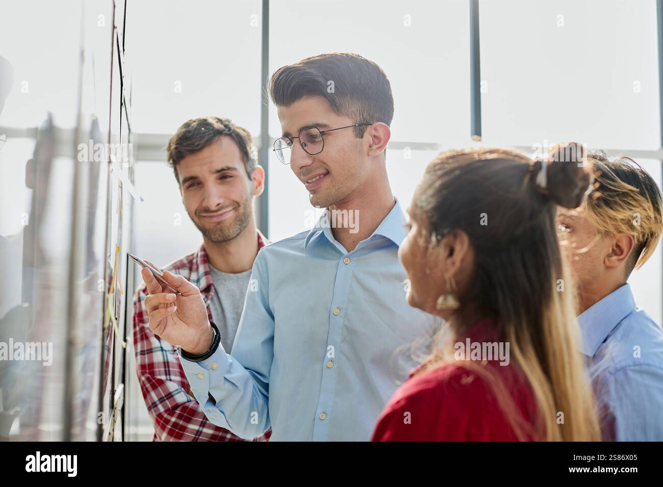 guy office worker writes a plan near the blackboard. startup ...