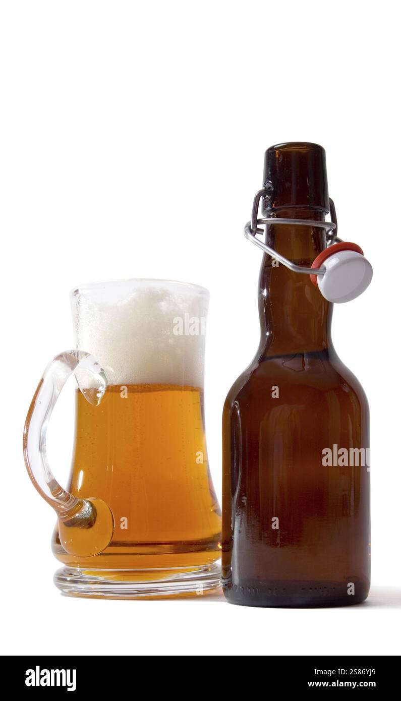 Full beer mug with amber beer, brown beer bottle in background Stock ...
