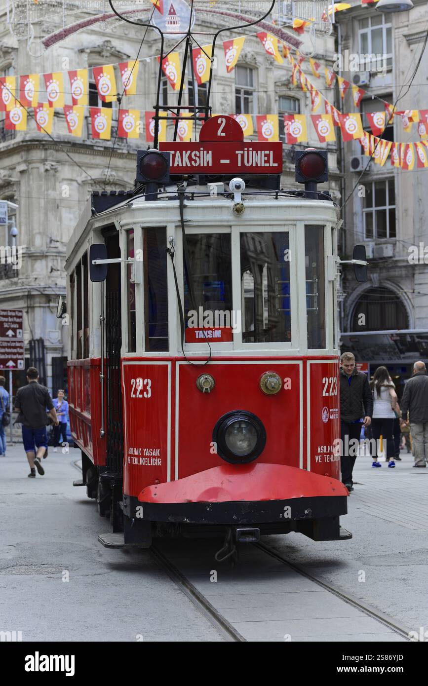 Historic tram Nostaljik Tramvay travelling through shopping street ...