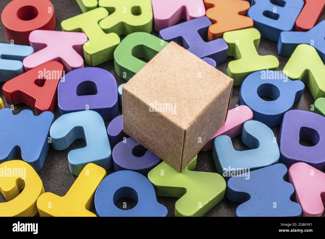 Cardboard box cube and Colorful Letters of Alphabet Stock Photo - Alamy