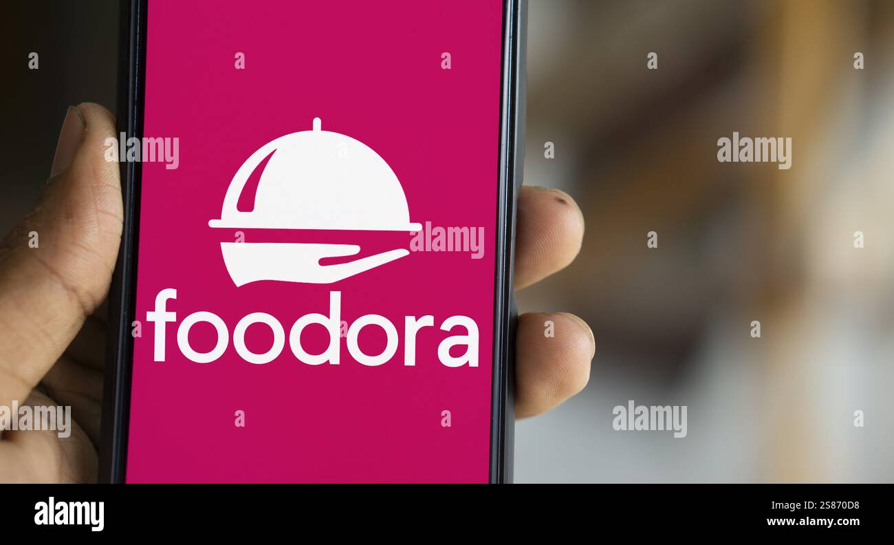Foodora logo is displayed on smartphone. Foodora is an online food ...