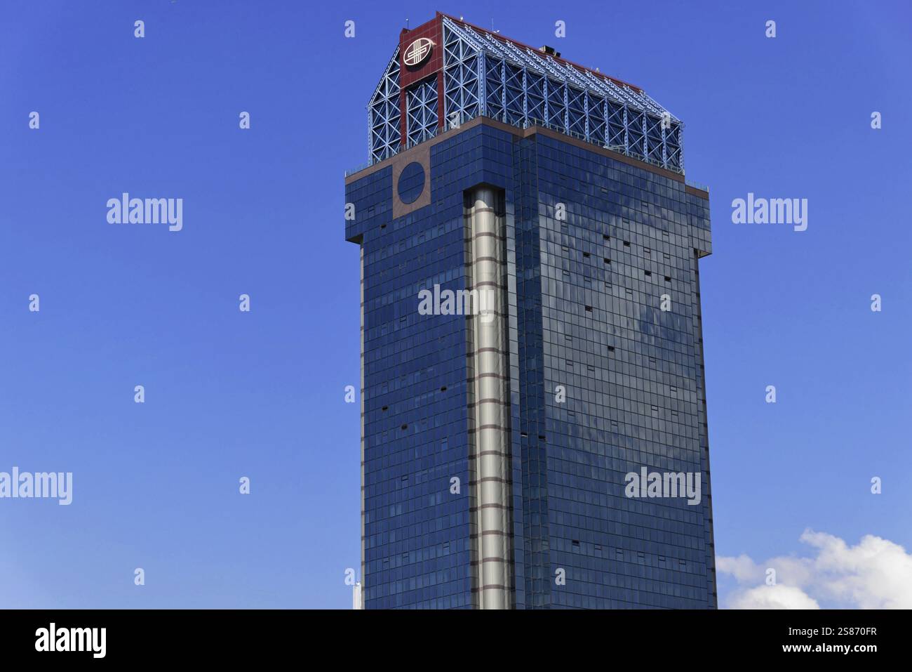 A tall modern tower with a glass facade and architectural design ...