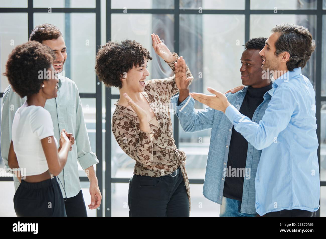 Successful business people giving each other a high five in a meeting ...