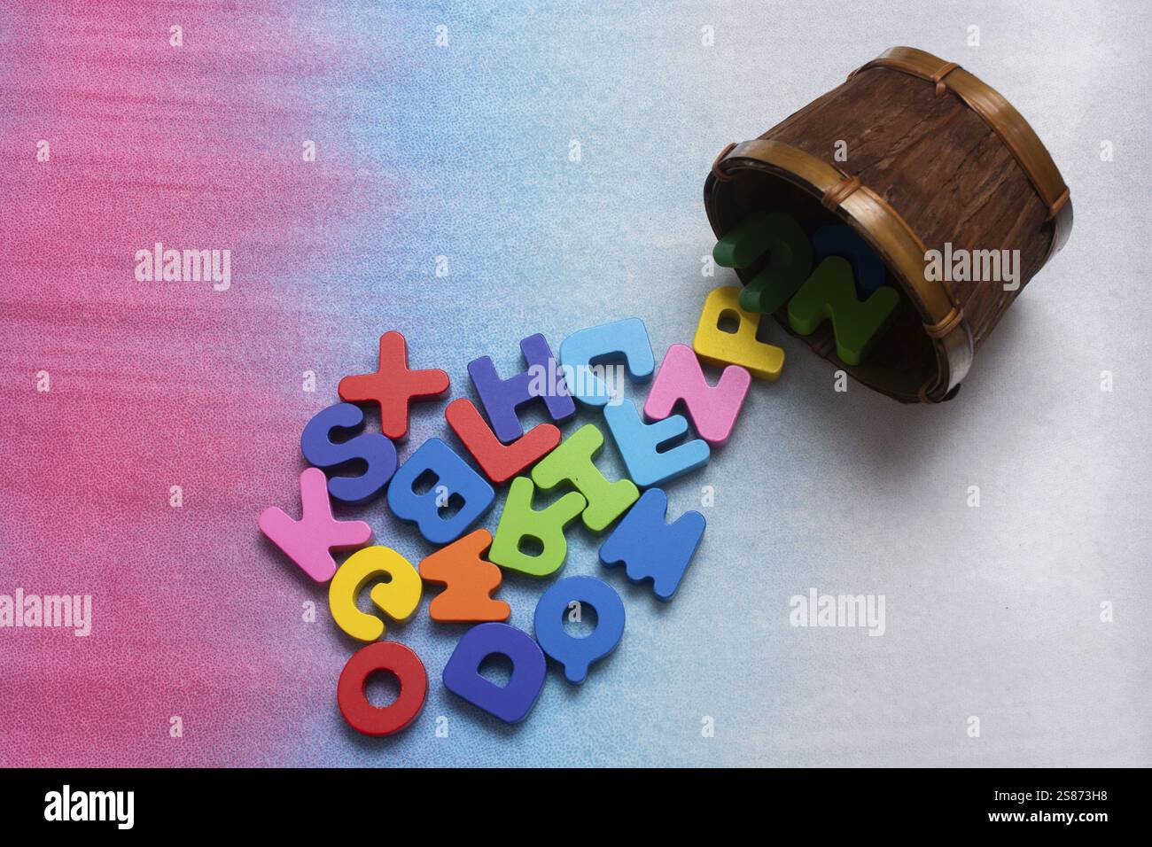 Colorful wooden letters in a container on a colorful background Stock ...