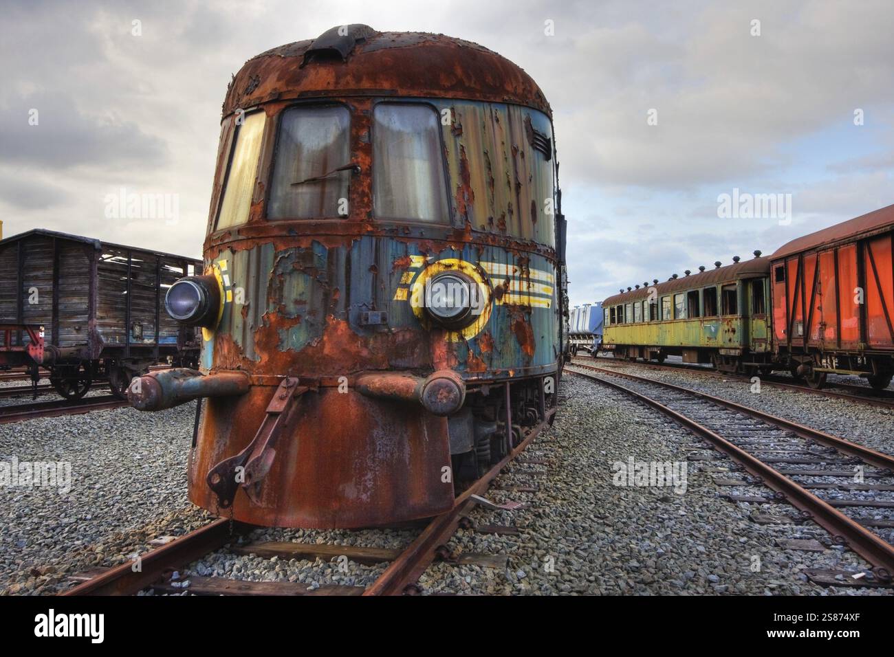 Abandoned railroad engine and carriages standing on rusty rails (an HDR ...