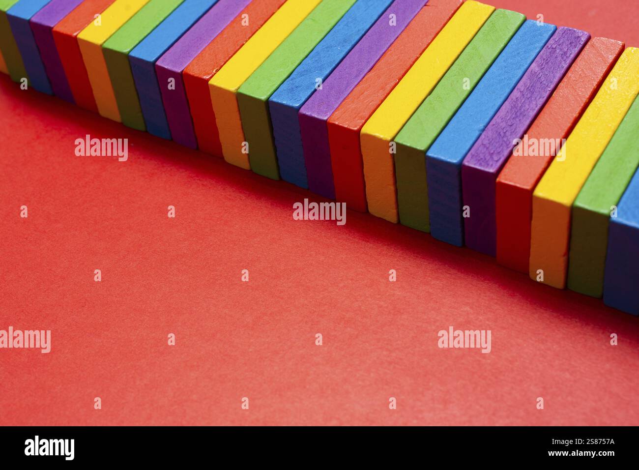 Colorful dominoes. Rainbow colored chain reaction Stock Photo - Alamy