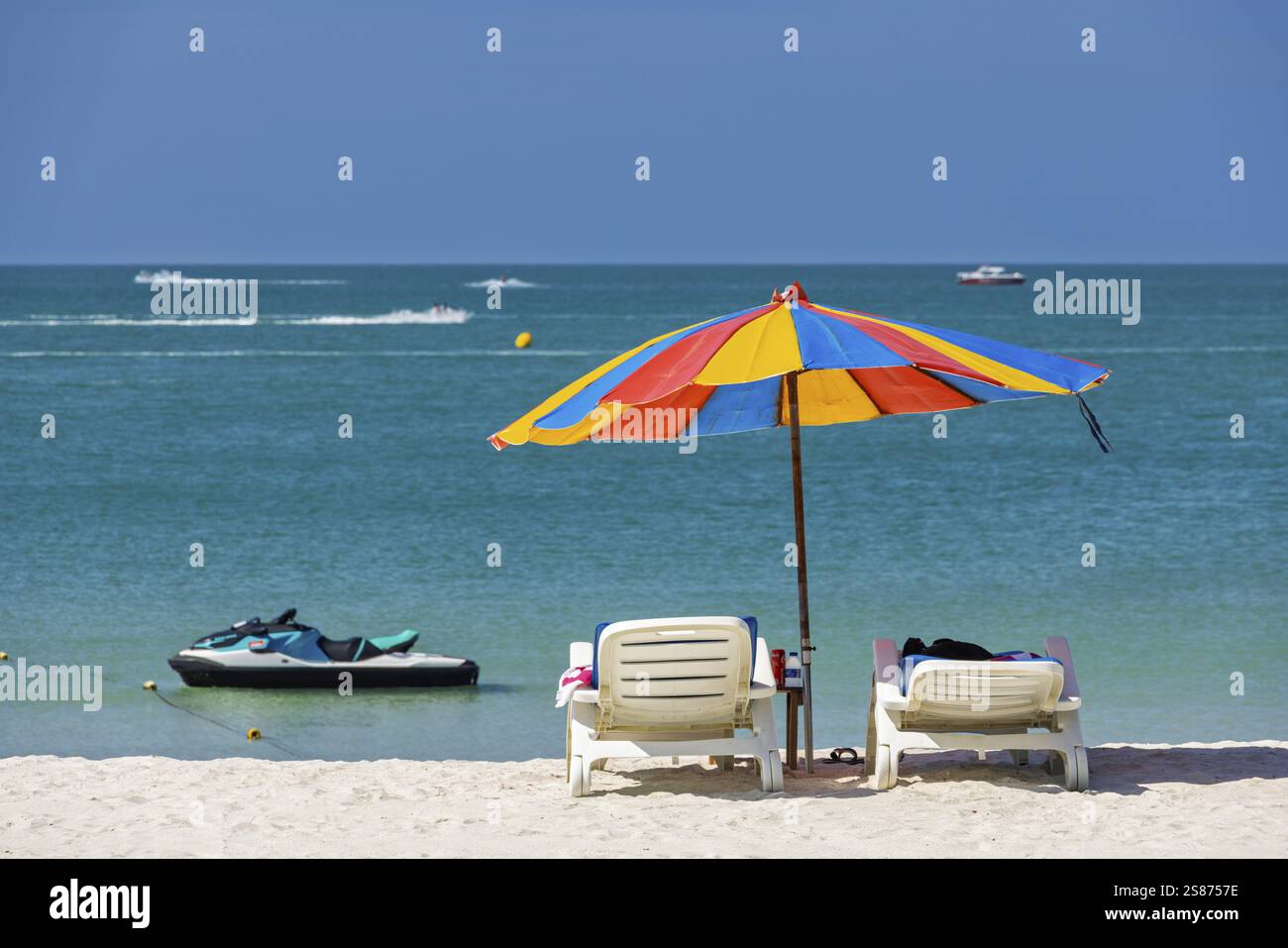 Parasol with sun loungers on the sandy beach, Chenang Beach, Langkawi ...