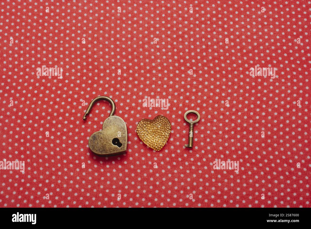 Heart shaped lock and key on a red background Stock Photo - Alamy