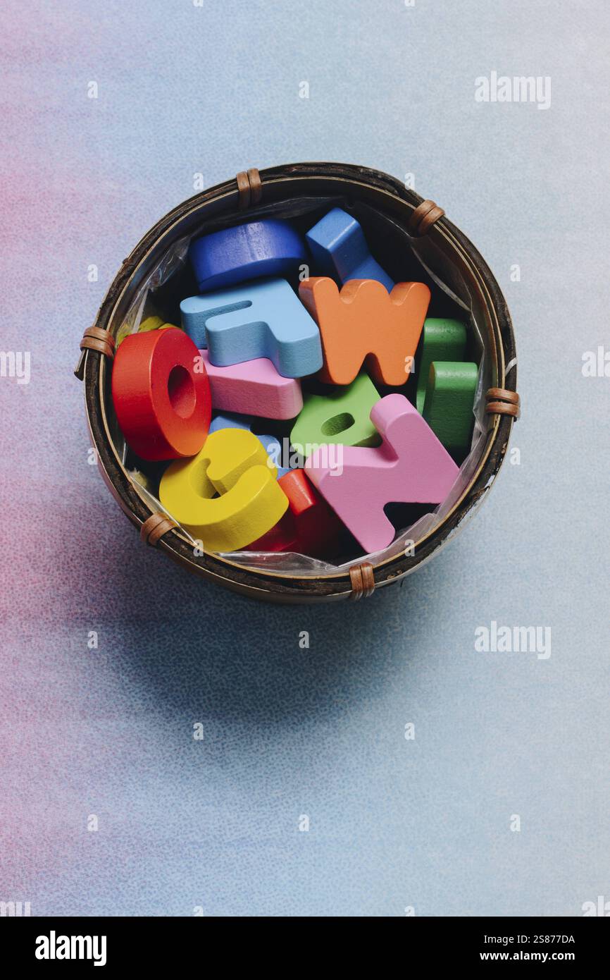 Colorful wooden letters in a container on a colorful background Stock ...
