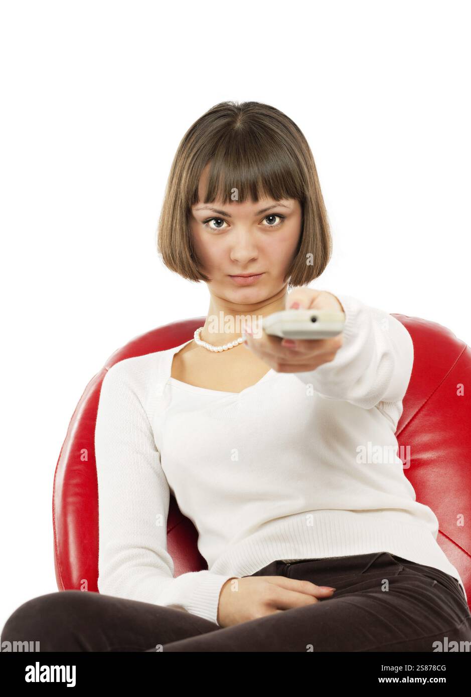 Pretty young woman pointing remote at TV, Russian Federation Stock ...