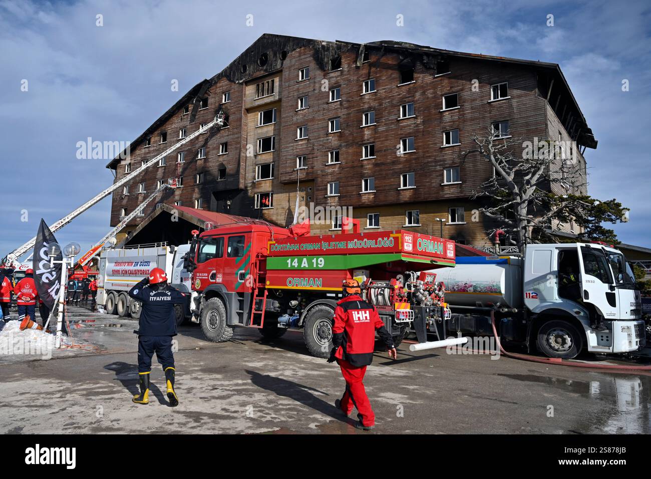 Firefighters workat the scene after a fire broke out at a hotel in the ...