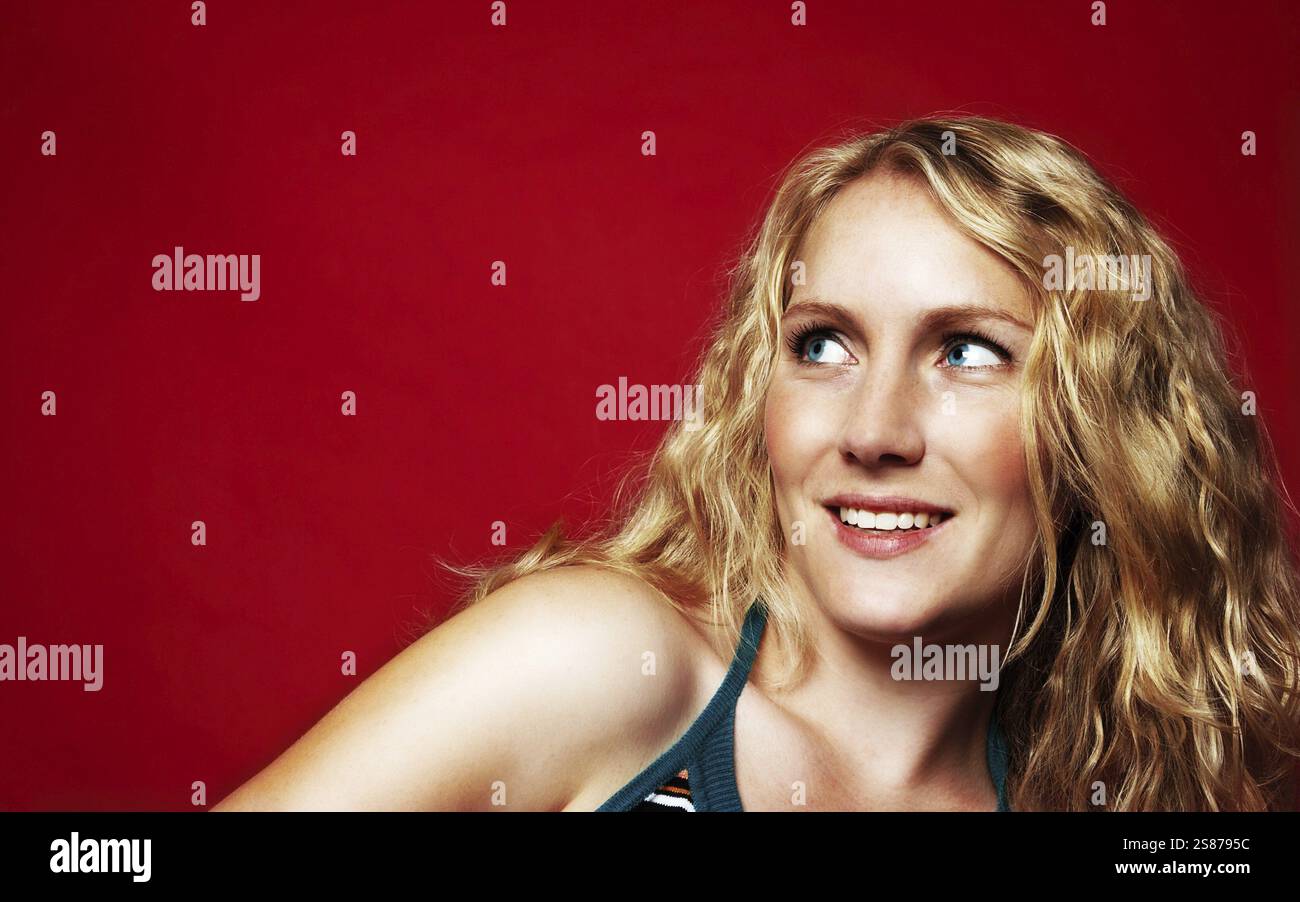 Portrait of a pretty blond girl on intense red background Stock Photo ...