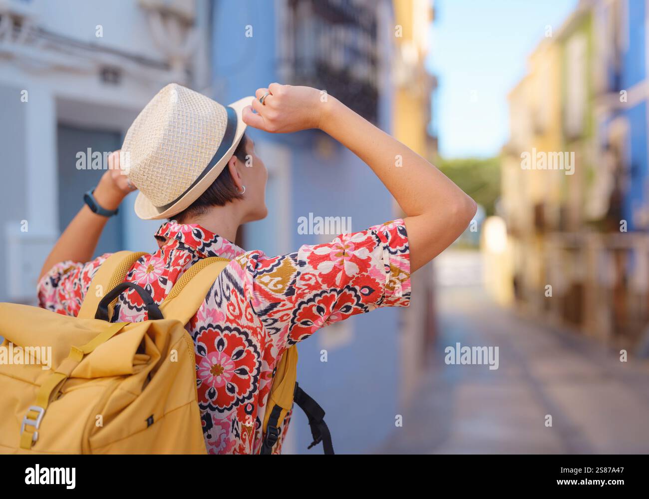 Tourism in Europe. Happy traveler girl visiting the colorful Spanish ...