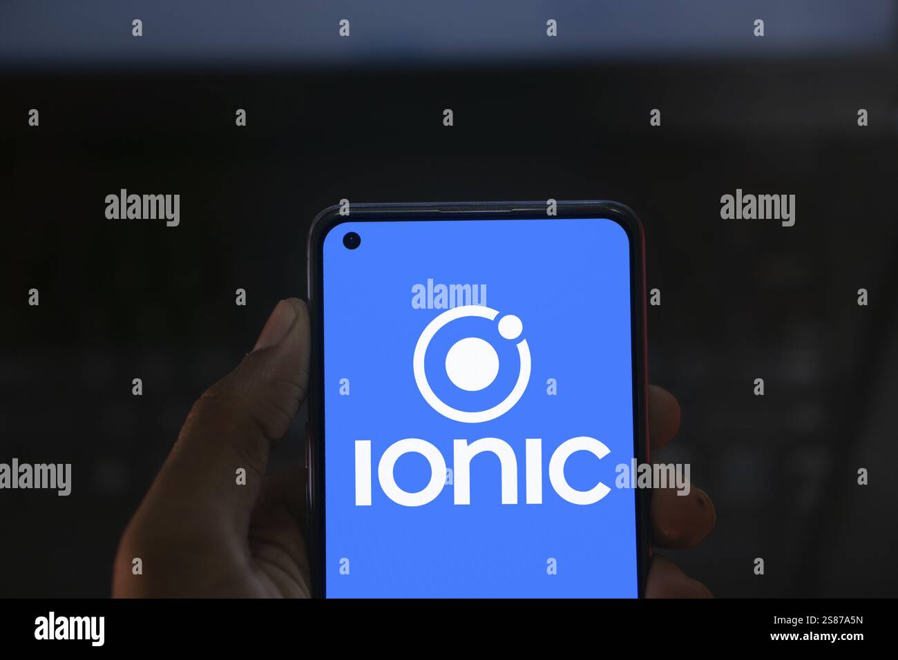 Ionic logo is displayed on smartphone. Ionic is an open-source UI toolkit for building cross ...