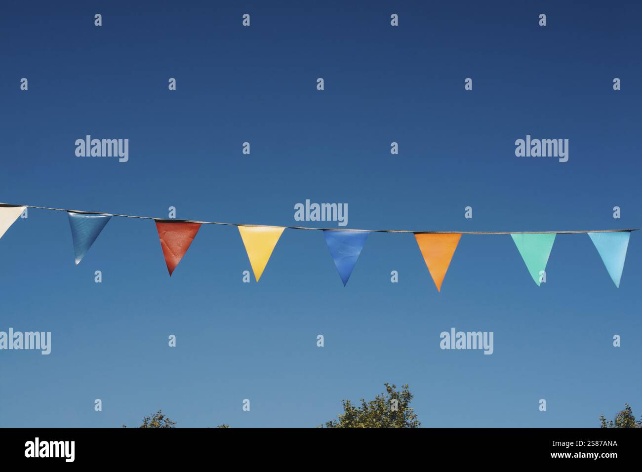 Colorful triangle bunting flags of various colors as festival concep ...