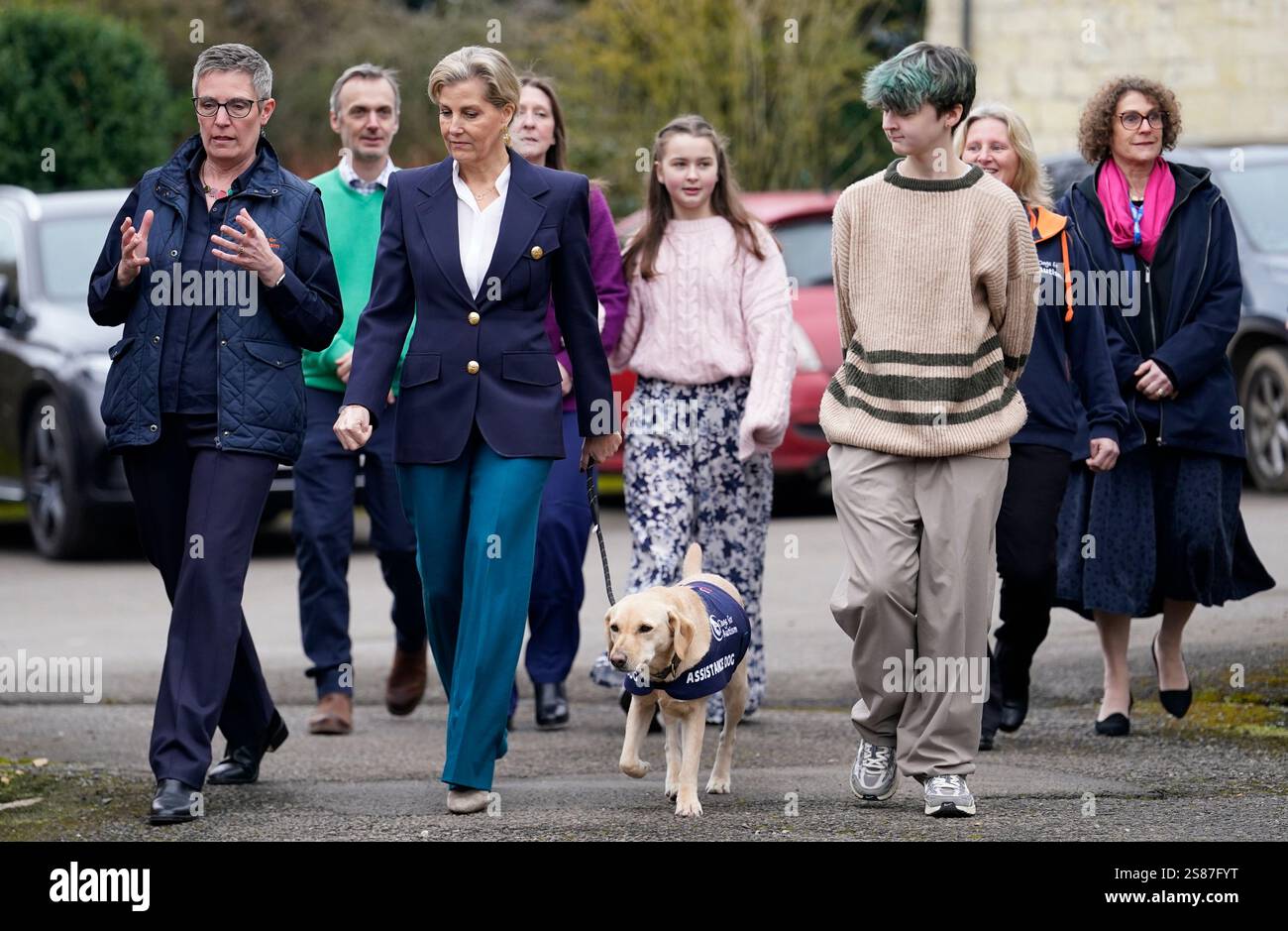The Duchess of Edinburgh (2nd left) walks assistance dog Clover ...