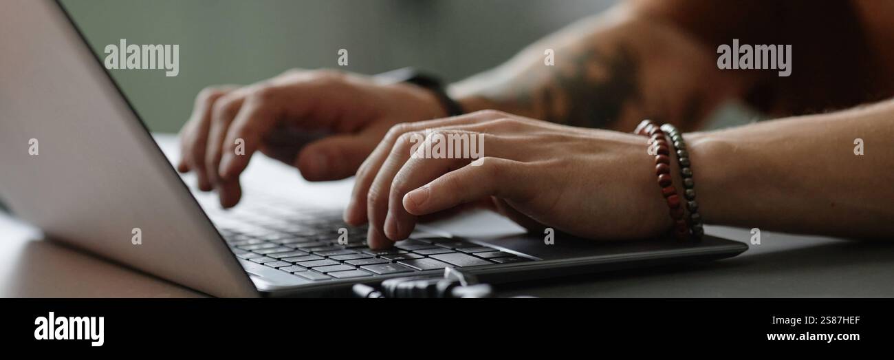 Website header shot male hands typing on keyboard of laptop writing ...