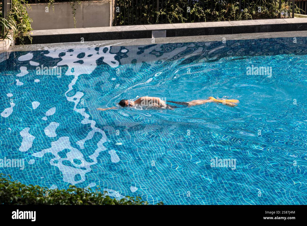 A man swimming in a small swimming pool in Ho Chi Minh City, Vietnam ...