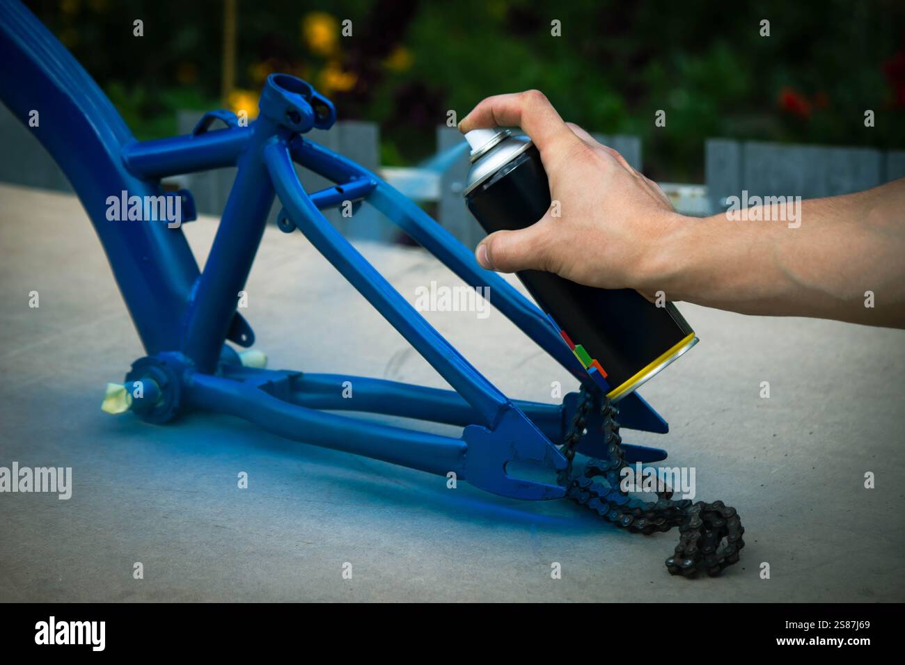 Spray Painting a Bicycle Frame Outdoors Stock Photo - Alamy