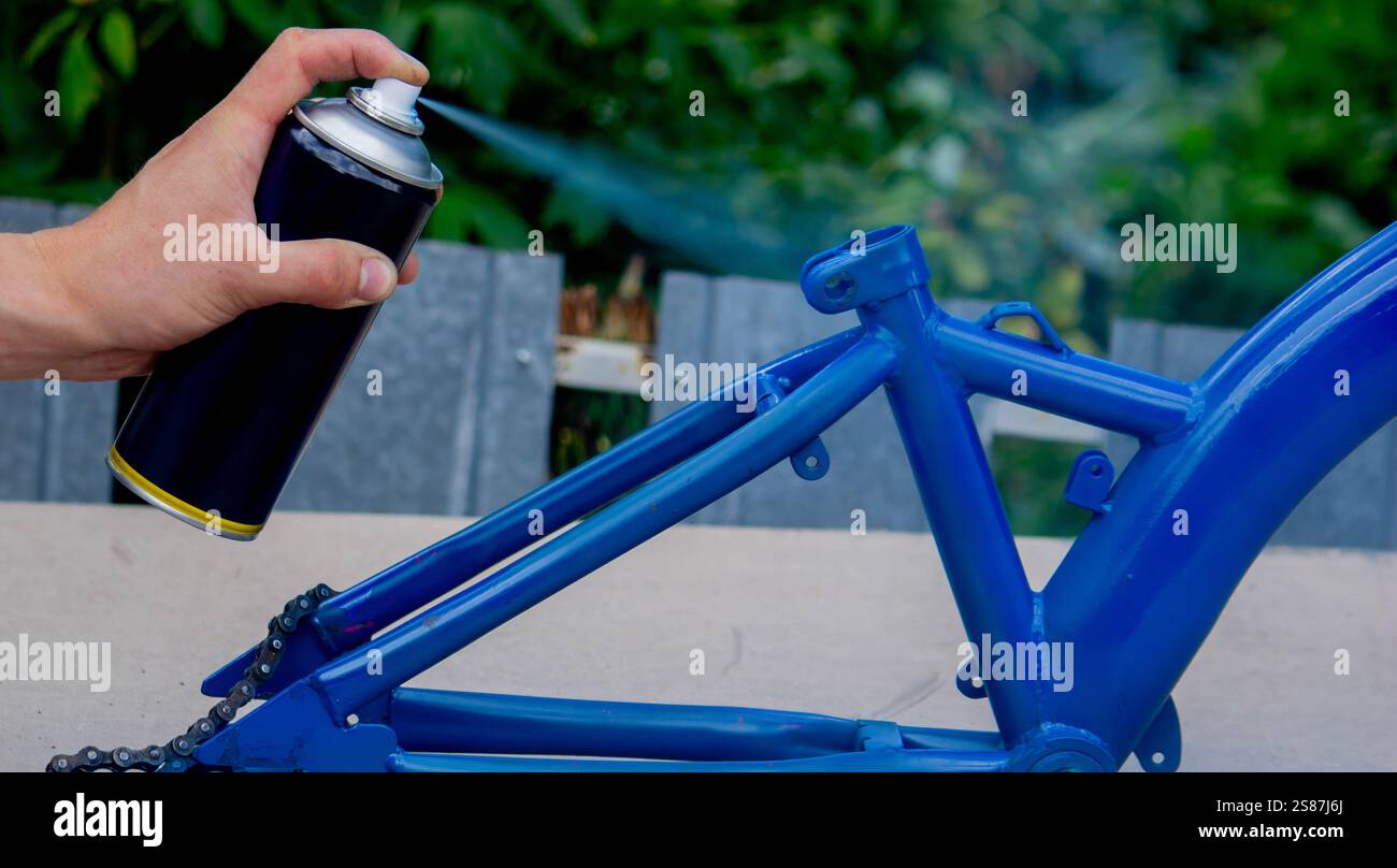 Spray Painting a Bicycle Frame Outdoors Stock Photo - Alamy