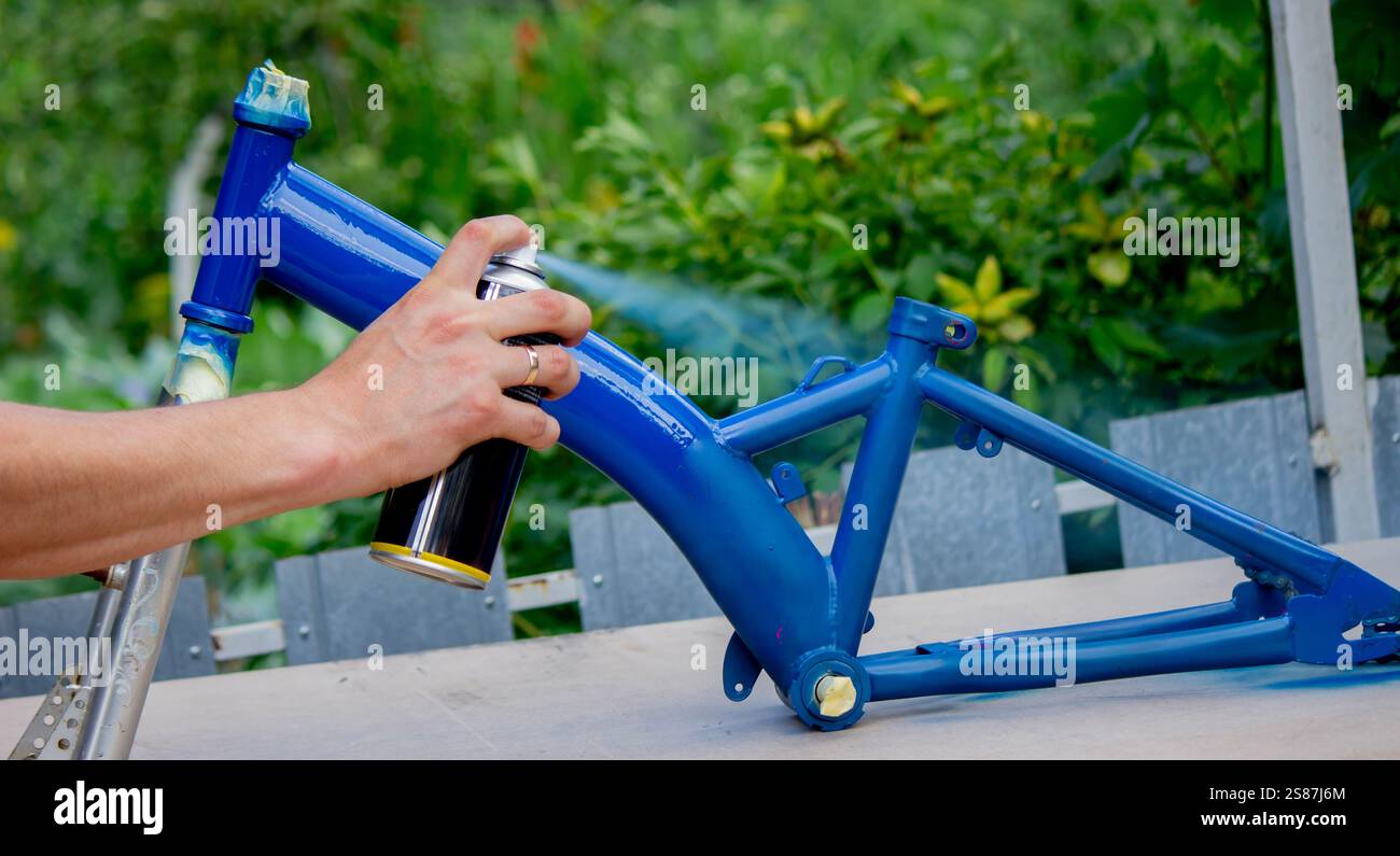 Spray Painting a Bicycle Frame Outdoors Stock Photo - Alamy