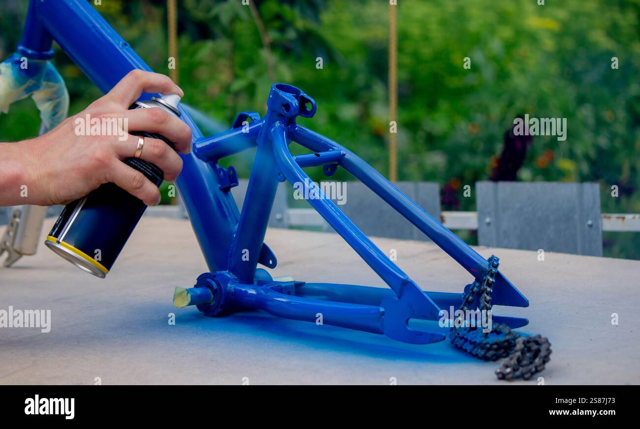 Spray Painting a Bicycle Frame Outdoors Stock Photo - Alamy