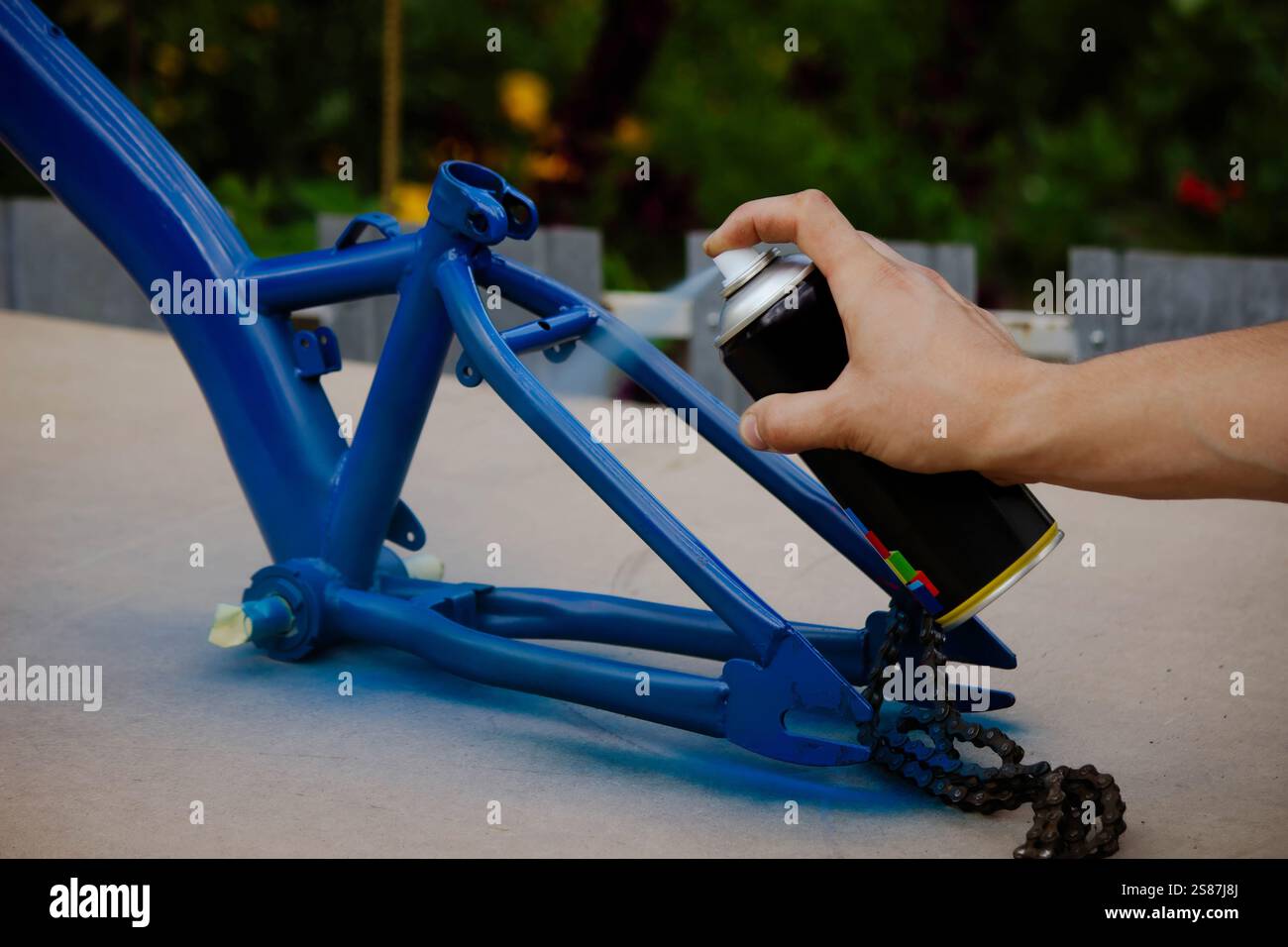 Spray Painting a Bicycle Frame Outdoors Stock Photo - Alamy