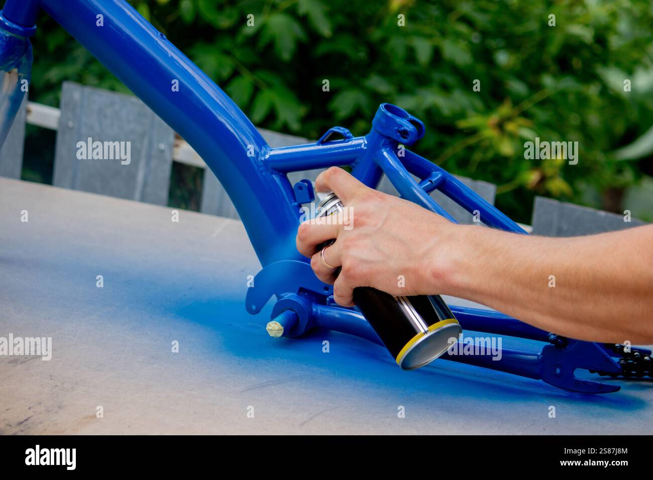 Spray Painting a Bicycle Frame Outdoors Stock Photo - Alamy