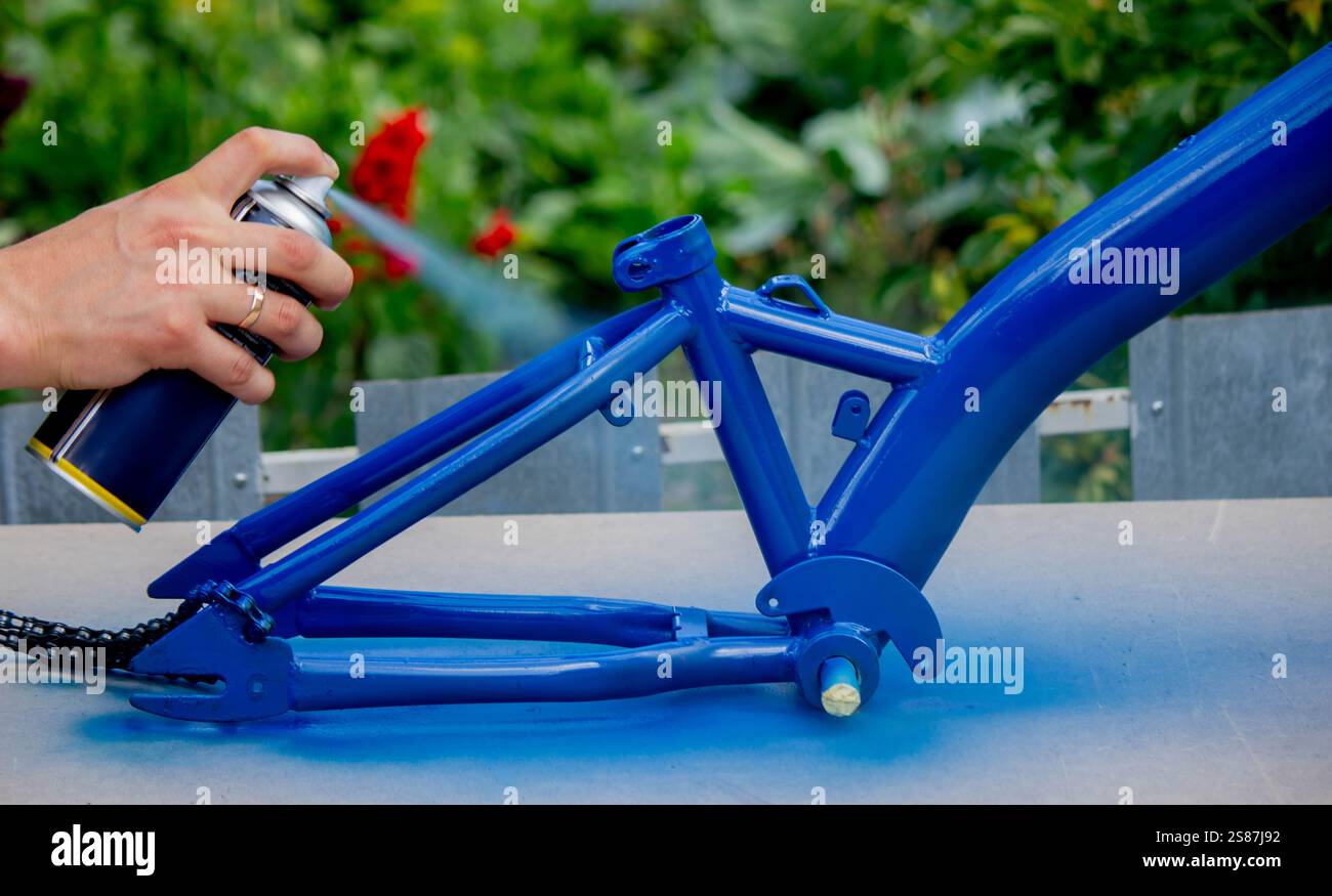 Spray Painting a Bicycle Frame Outdoors Stock Photo - Alamy