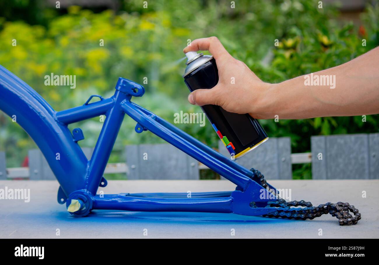 Spray Painting a Bicycle Frame Outdoors Stock Photo - Alamy