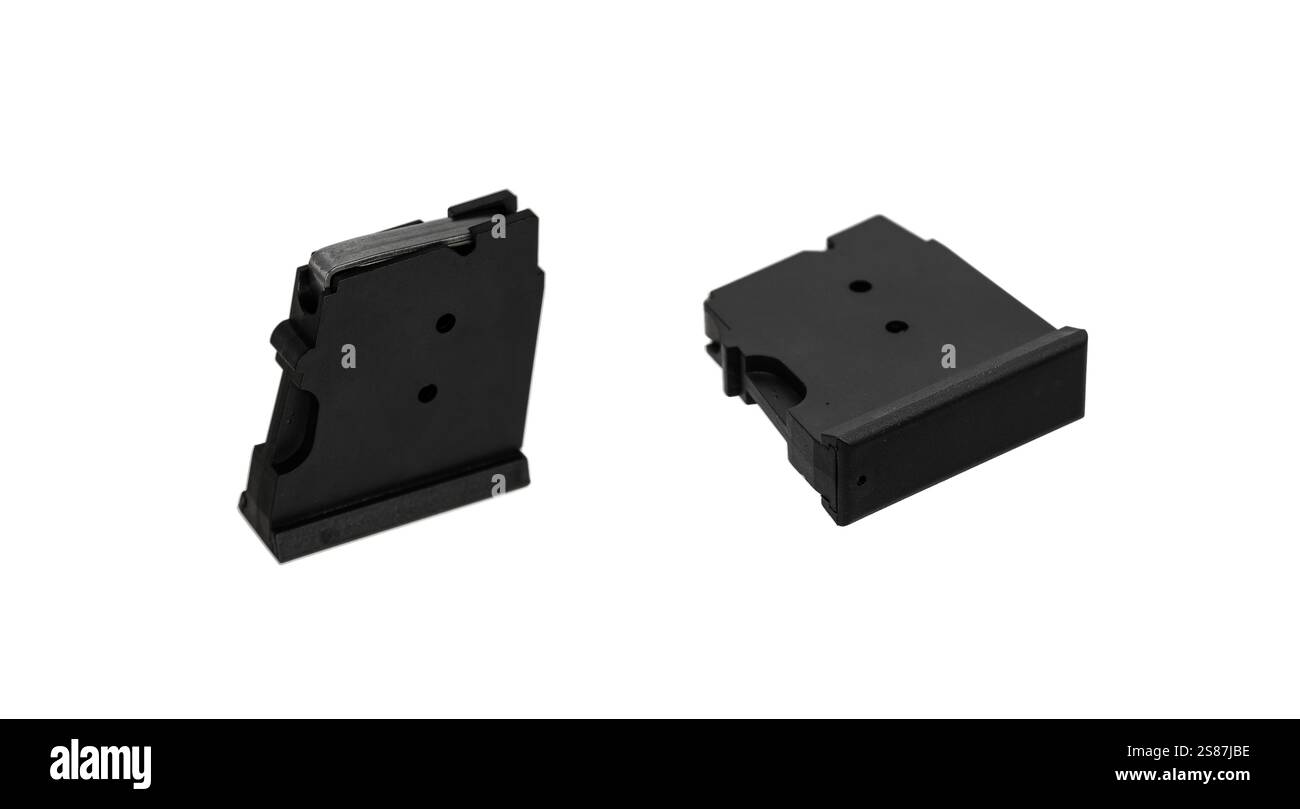 Two black .22lr caliber rifle magazines, one standing upright and the ...