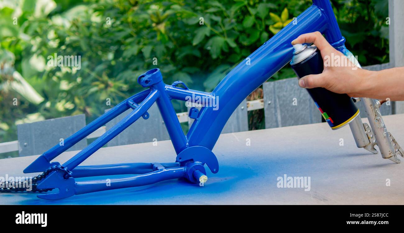 Spray Painting a Bicycle Frame Outdoors Stock Photo - Alamy