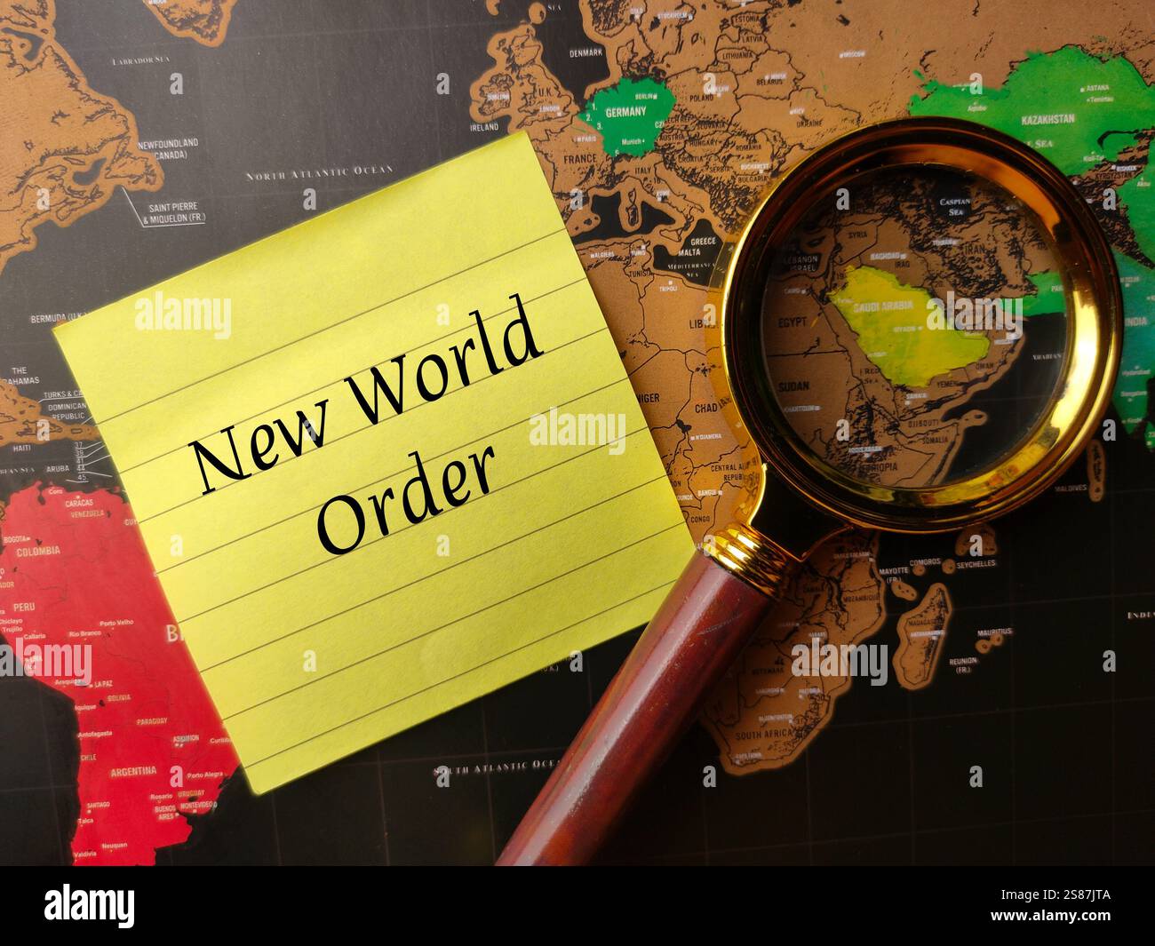 Magnifying glass and sticky note with text New World Order on a world ...