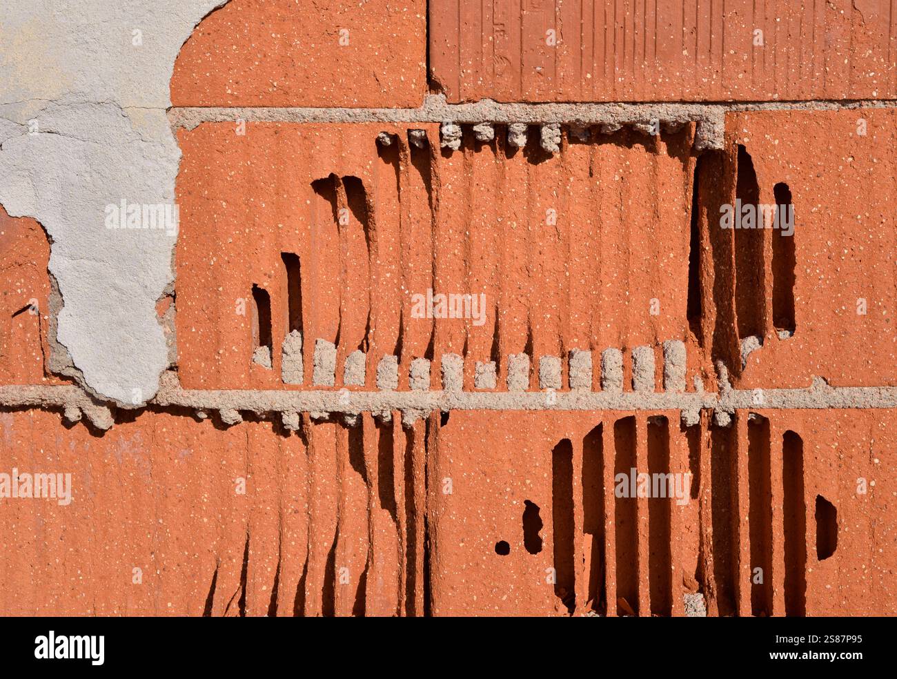 damaged perforated bricks wall Stock Photo - Alamy