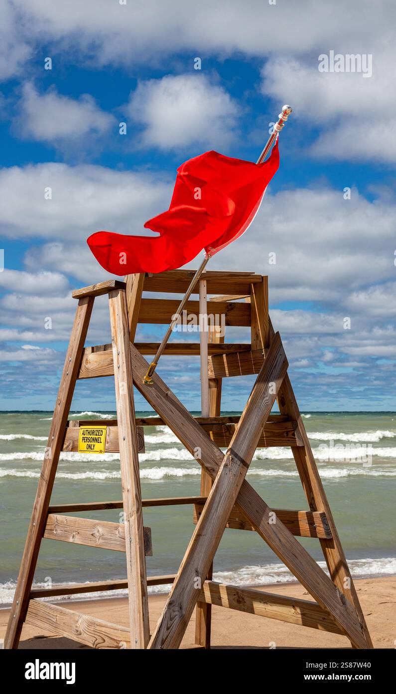 Red warning flag on a lifeguard chair at the beach Stock Photo - Alamy