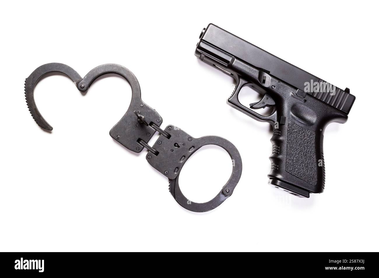 gun and handcuffs on white background Stock Photo - Alamy