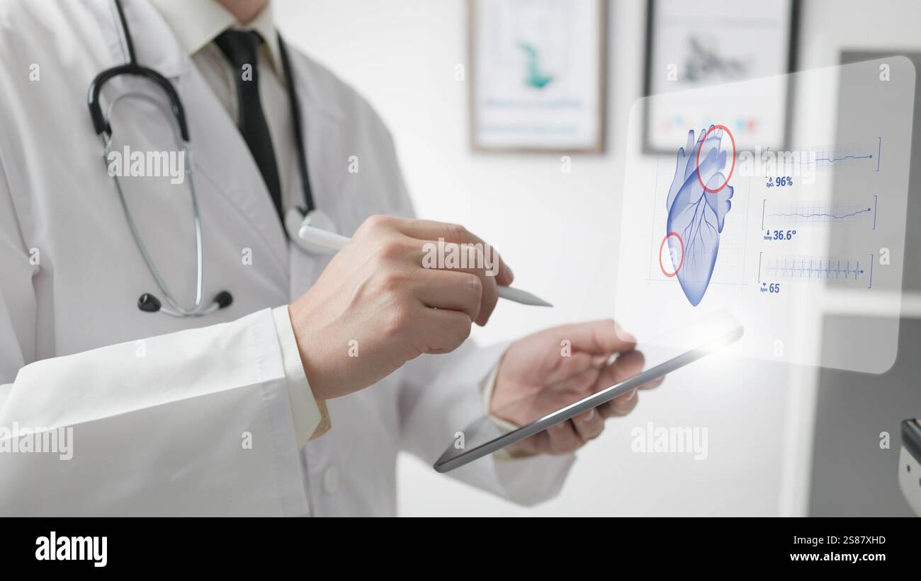 A doctor examines a hologram of the human heart with warnings of ...