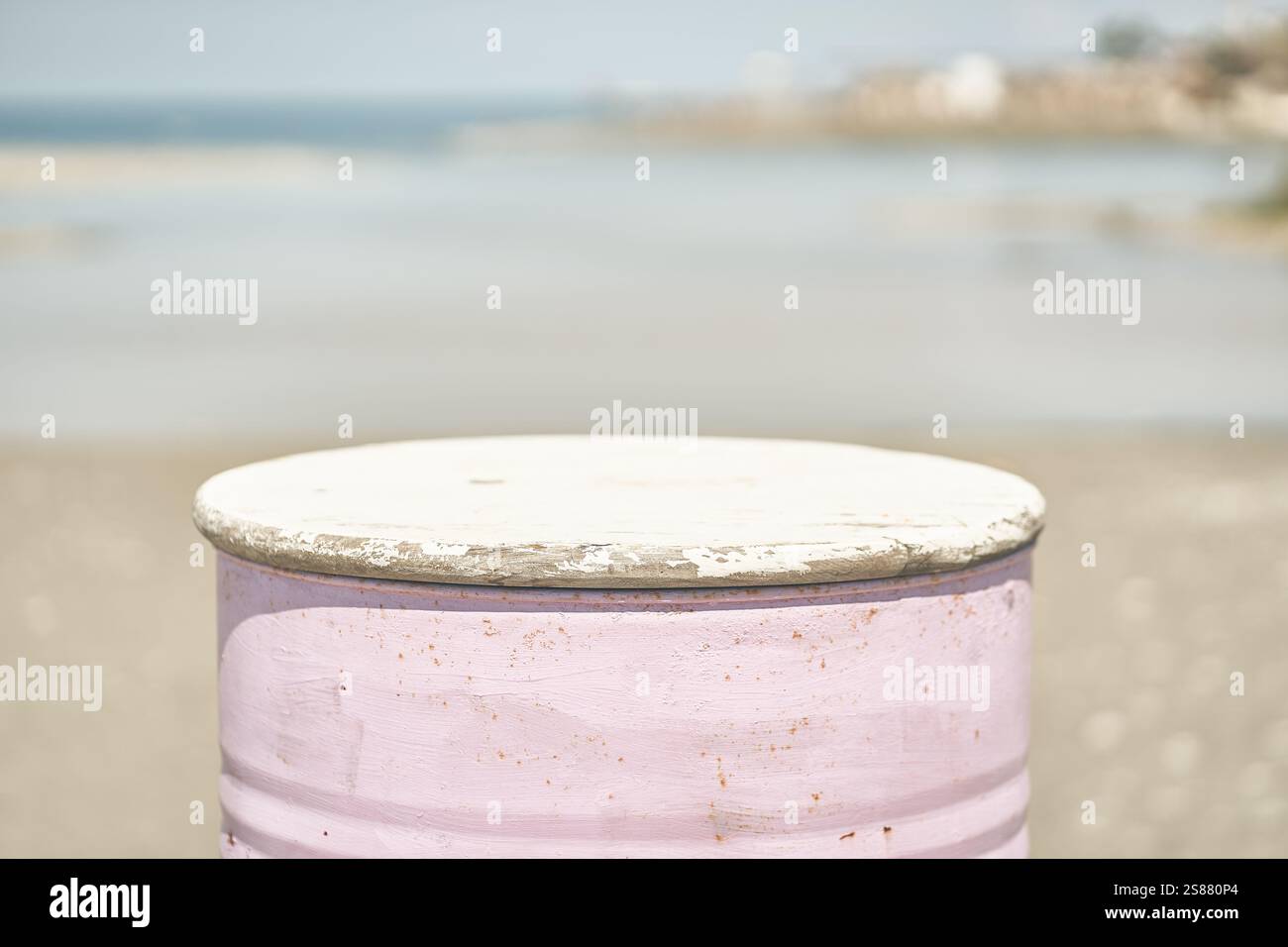 A pink oil barrel stands against the background of the sea. The natural ...