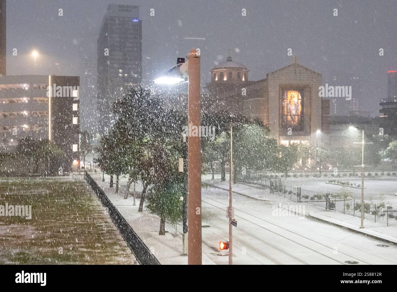 The Houston skyline is visible in the background as snow covers ...