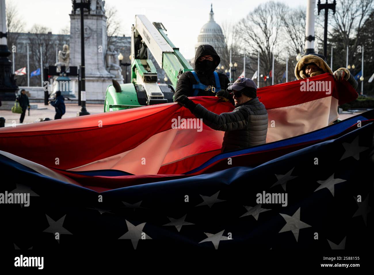 Workers remove decorative American flags from President Donald Trump’s ...
