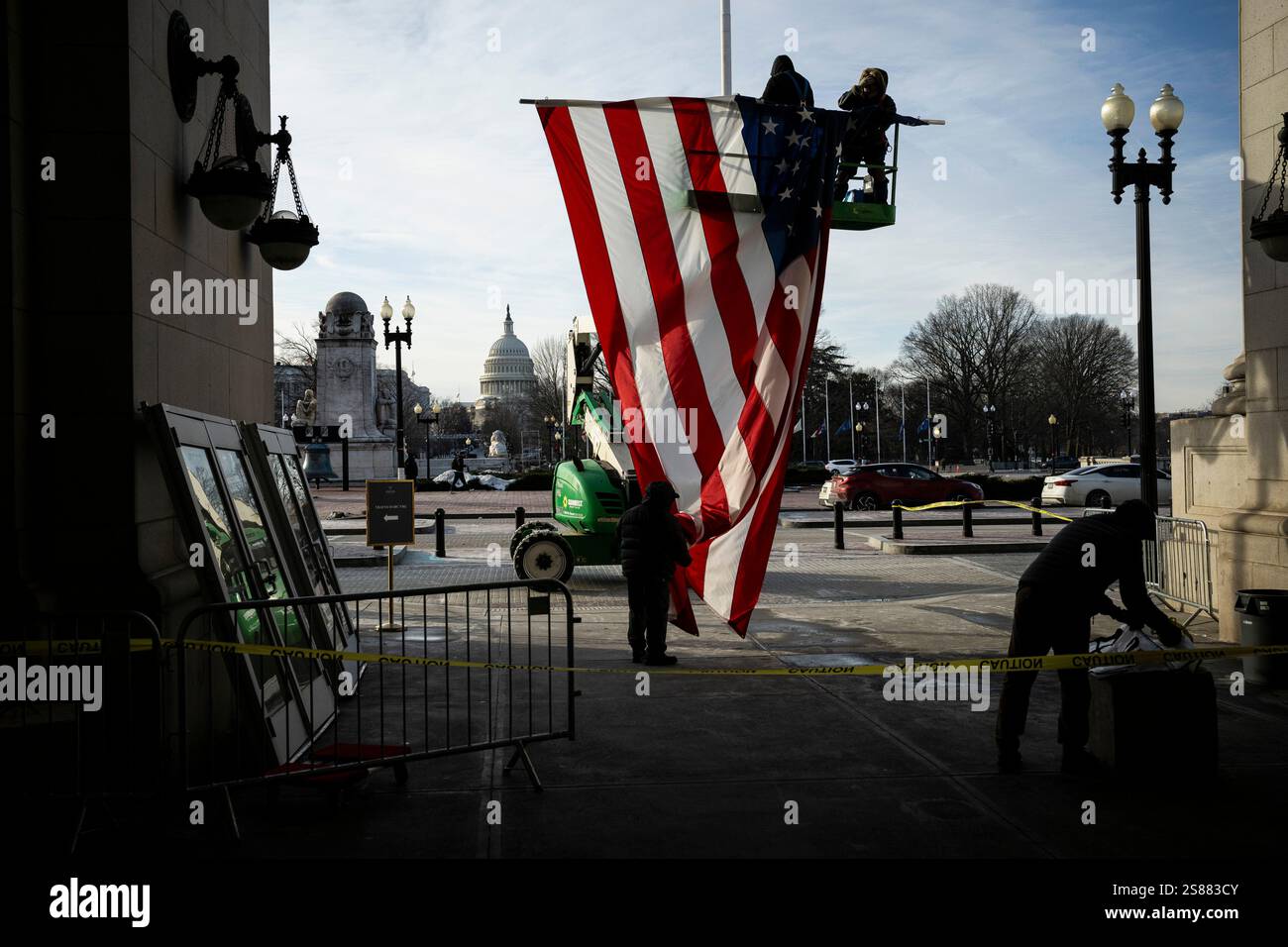 Workers remove decorative American flags from President Donald Trump’s ...