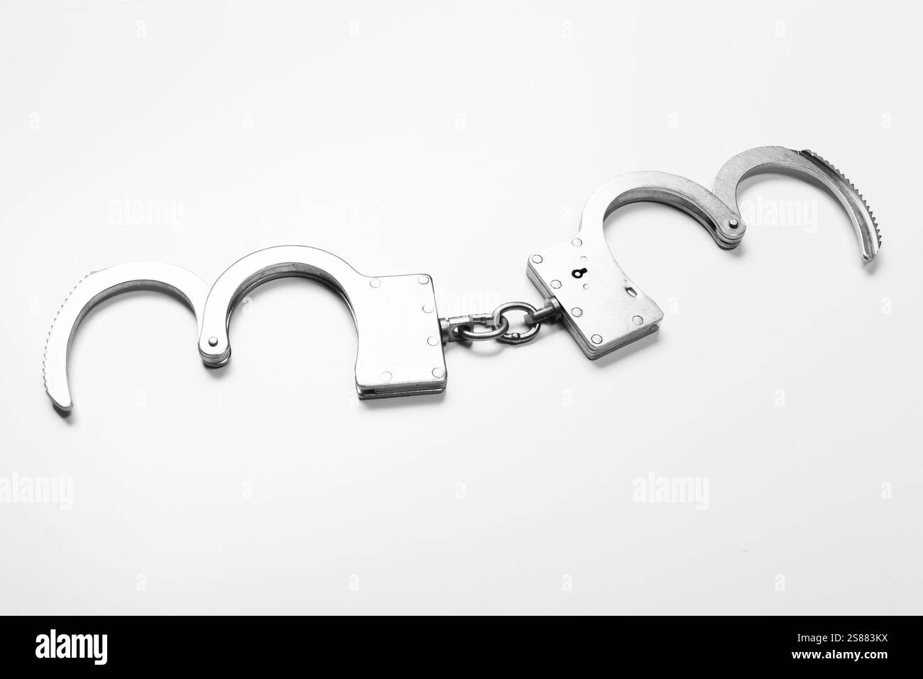 handcuffs isolated in white Stock Photo - Alamy